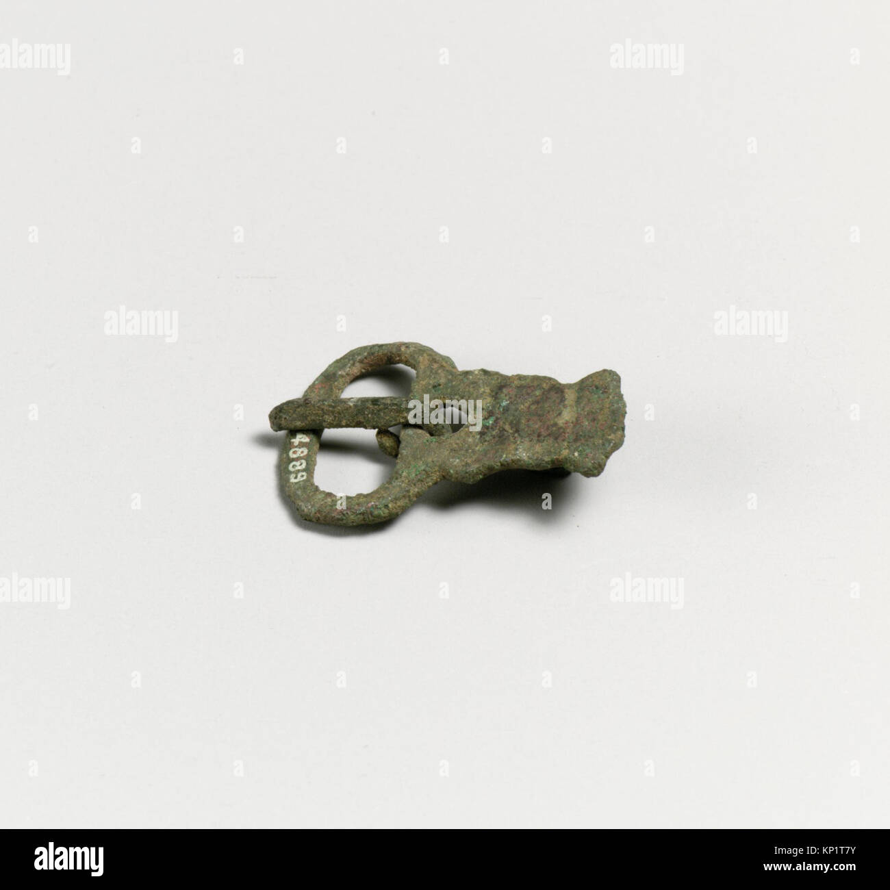 This ancient buckle, dating back to early civilizations, showcases the ...