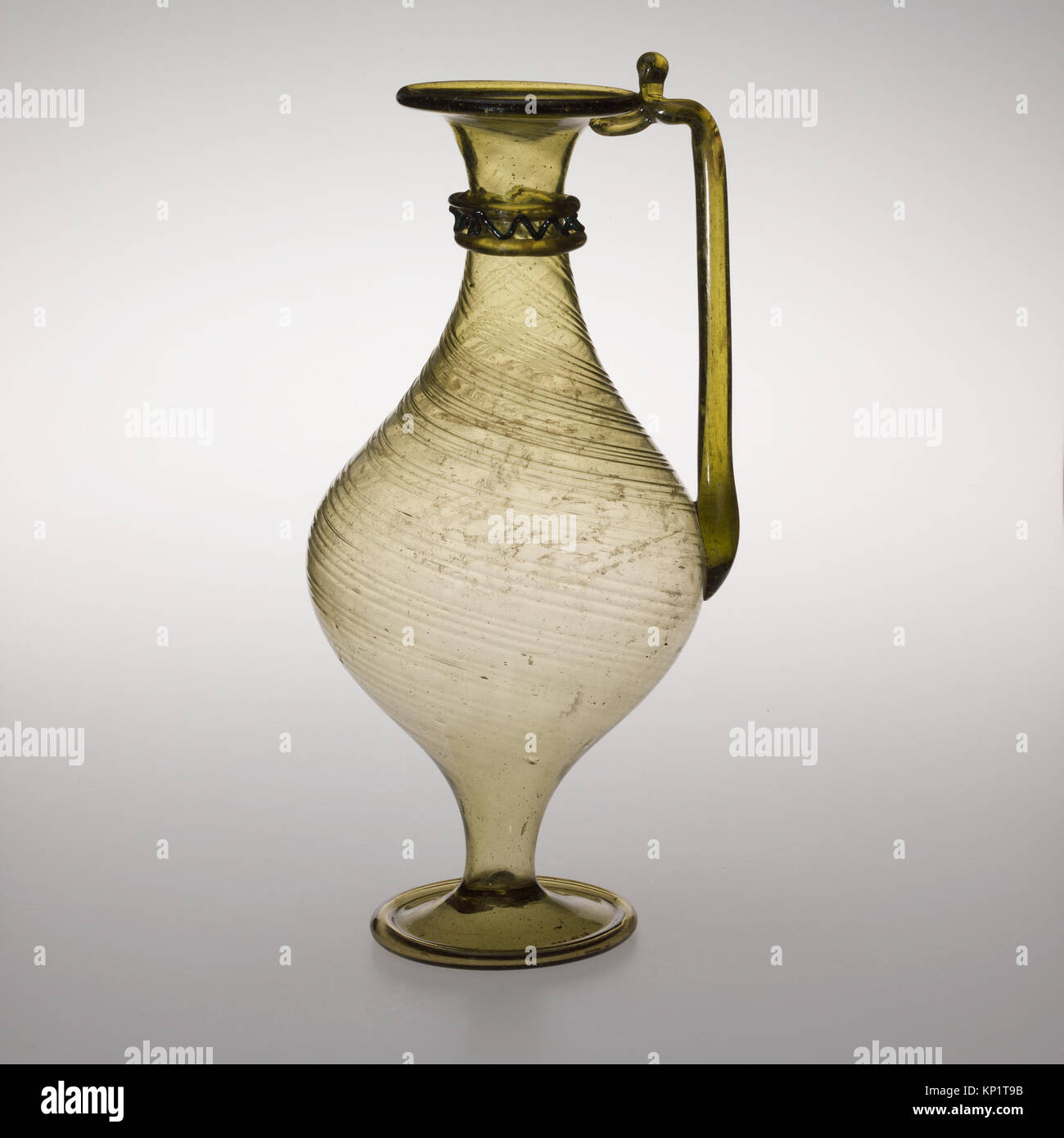 A rounded glass jug with an open mouth, intended for storing and ...