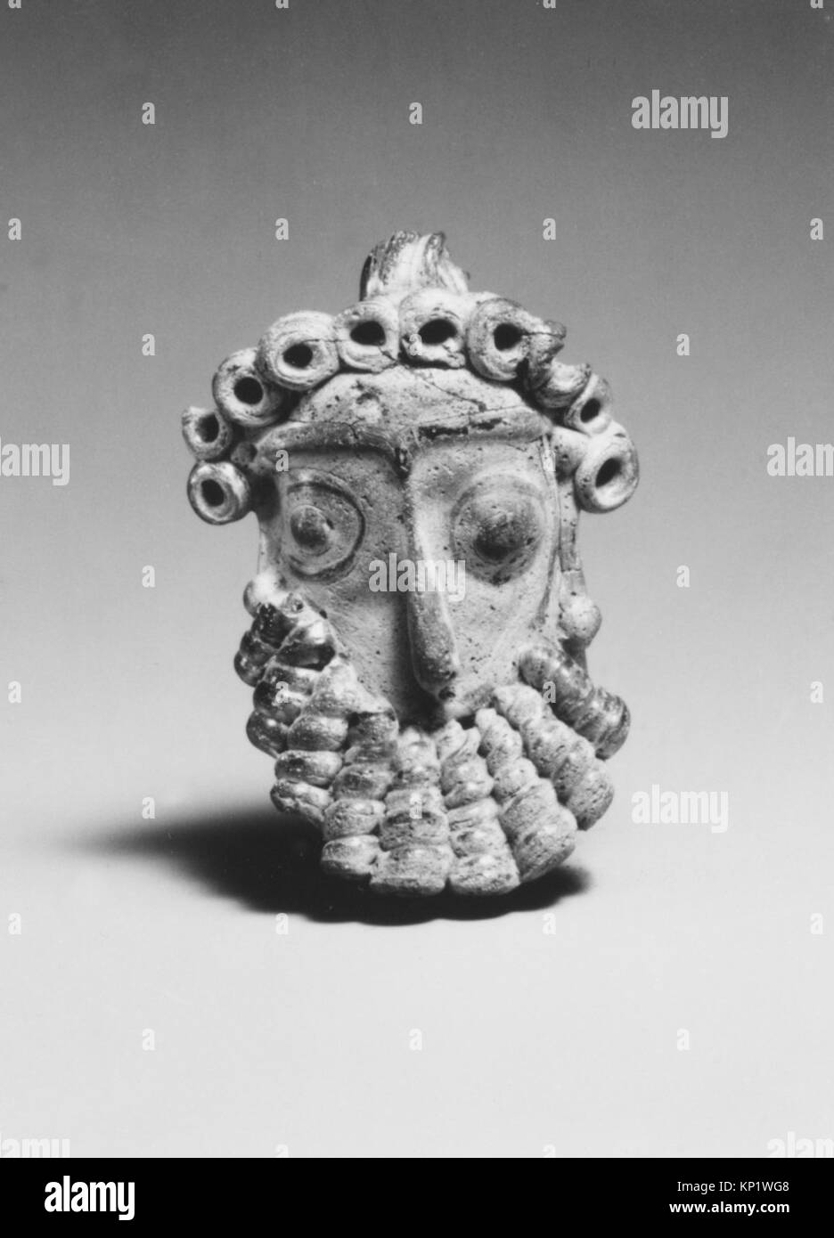 A human-head-shaped glass pendant, created as a piece of decorative ...