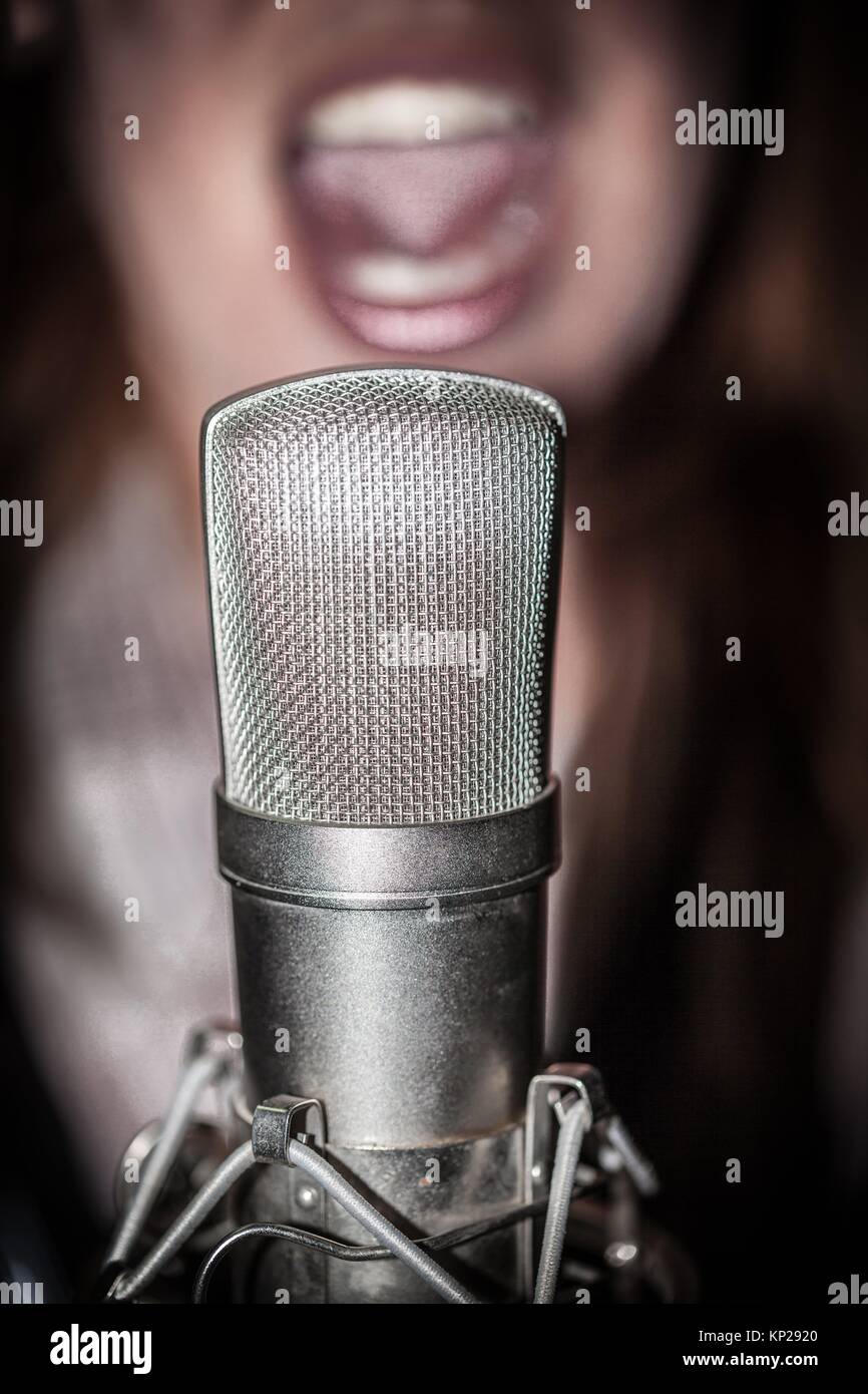 Woman speaking into microphone hi-res stock photography and images - Alamy