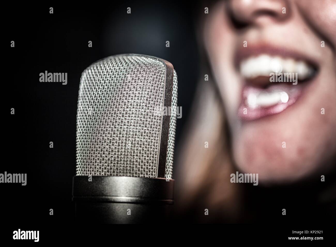 Woman Speaking Into Microphone High Resolution Stock Photography and ...