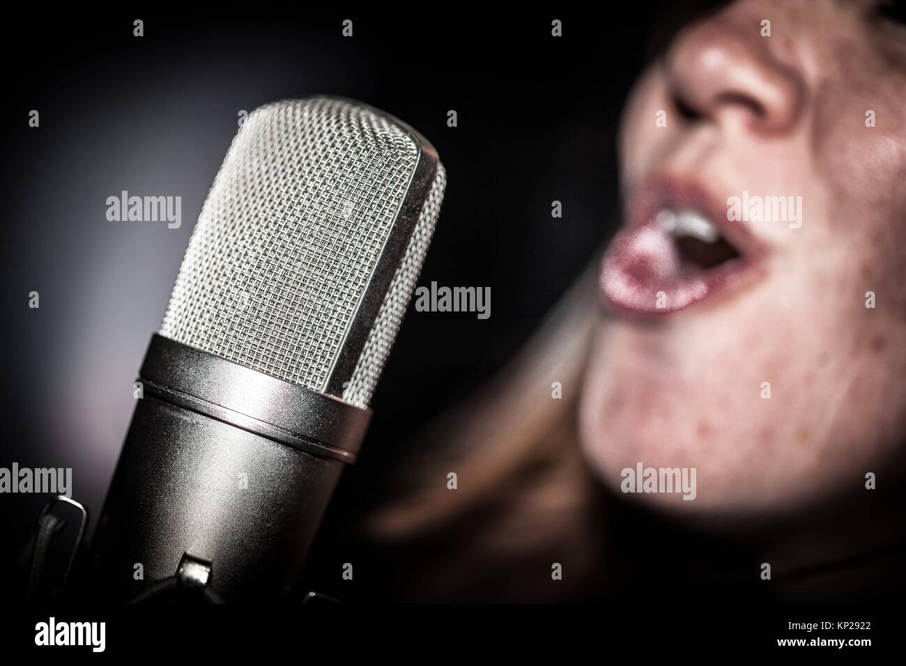 Woman speaking into microphone hi-res stock photography and images - Alamy