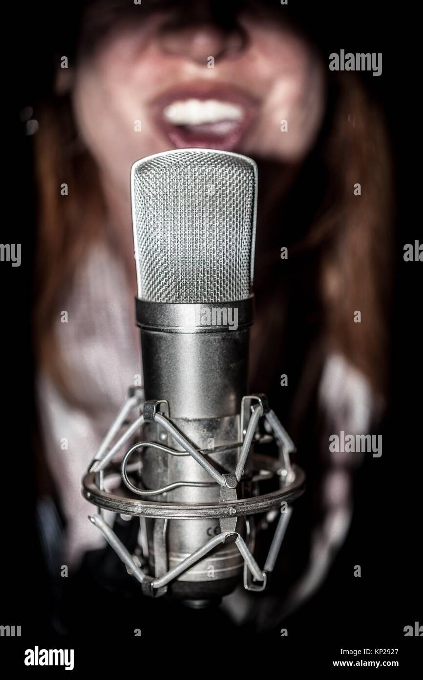 Woman Speaking Into Microphone High Resolution Stock Photography and ...