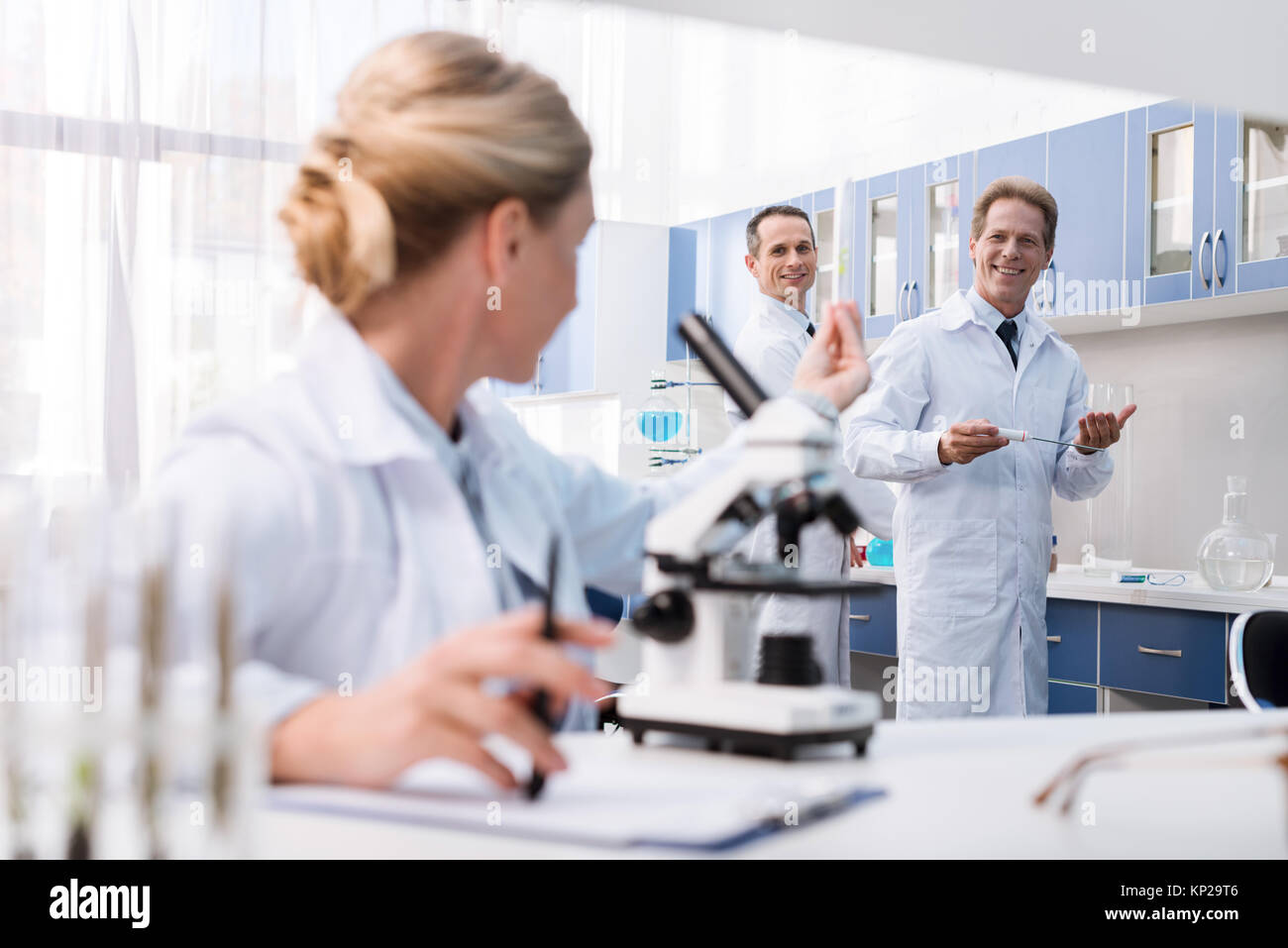 scientists examining test tube Stock Photo - Alamy