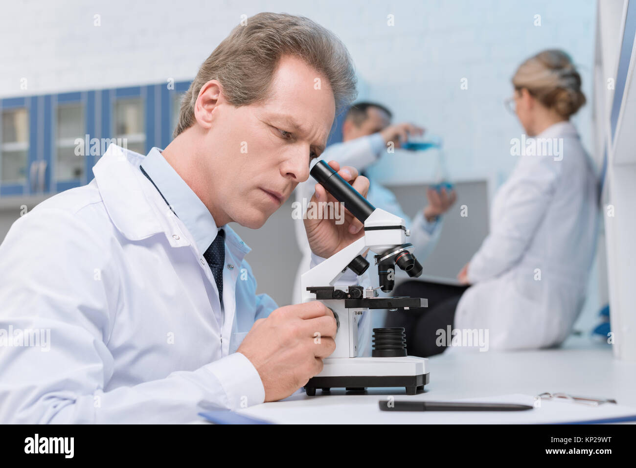 scientist working with microscope Stock Photo - Alamy
