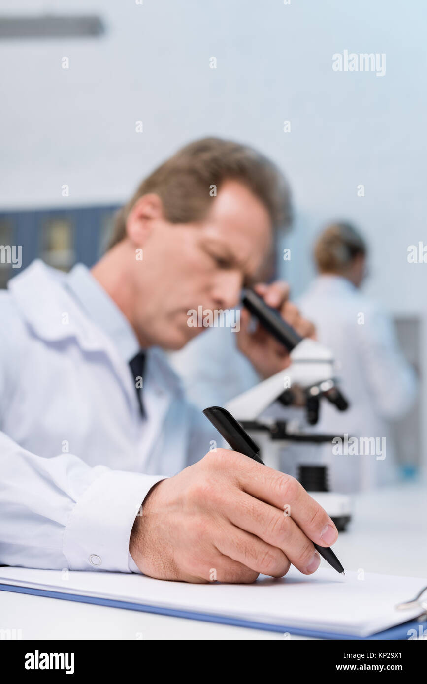 lab technician taking notes Stock Photo - Alamy