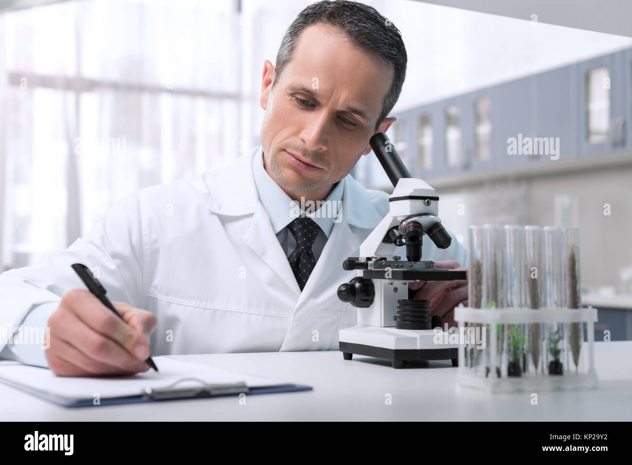 lab technician taking notes Stock Photo - Alamy