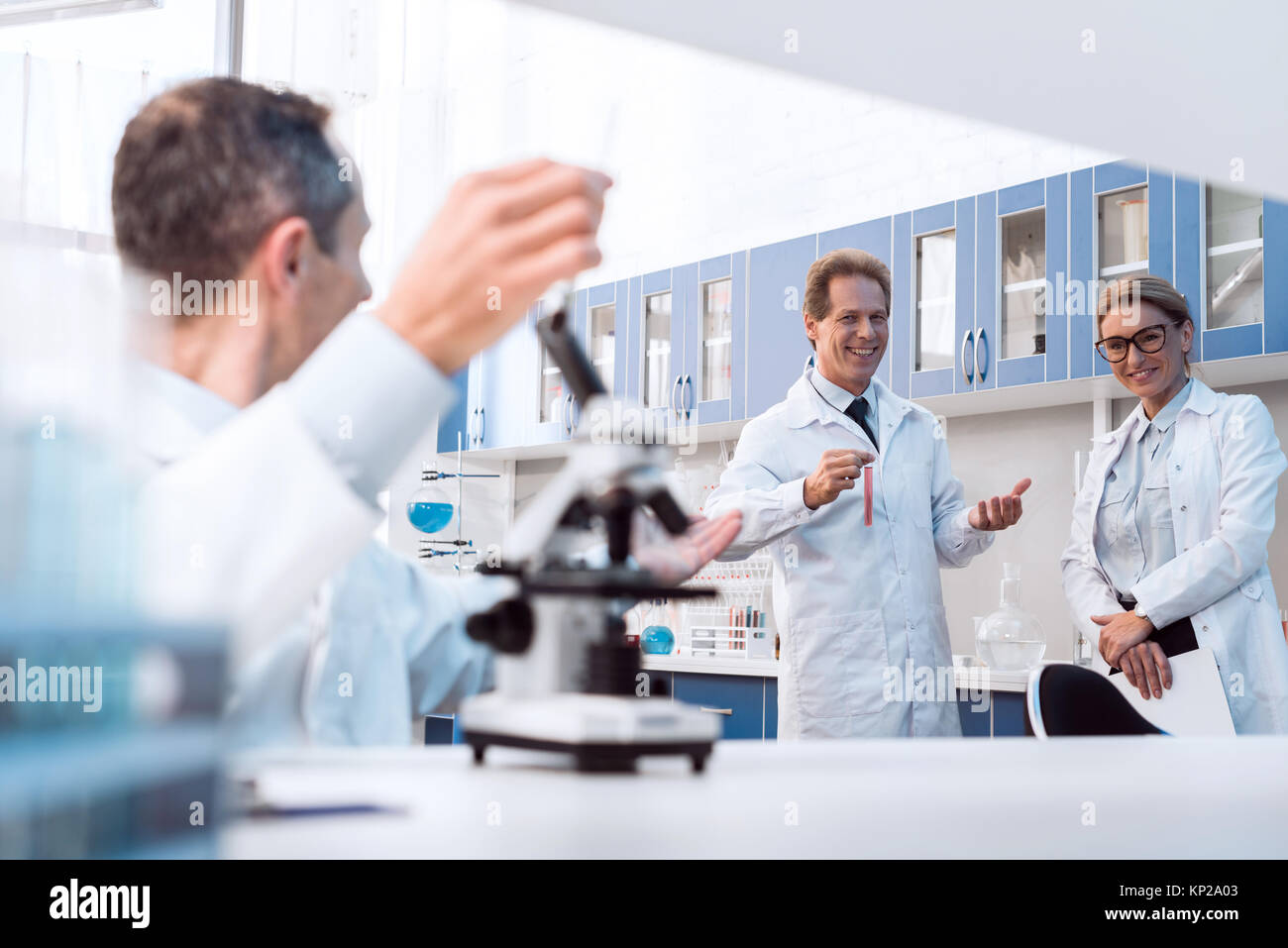 Scientists microscope blue liquid hi-res stock photography and images ...