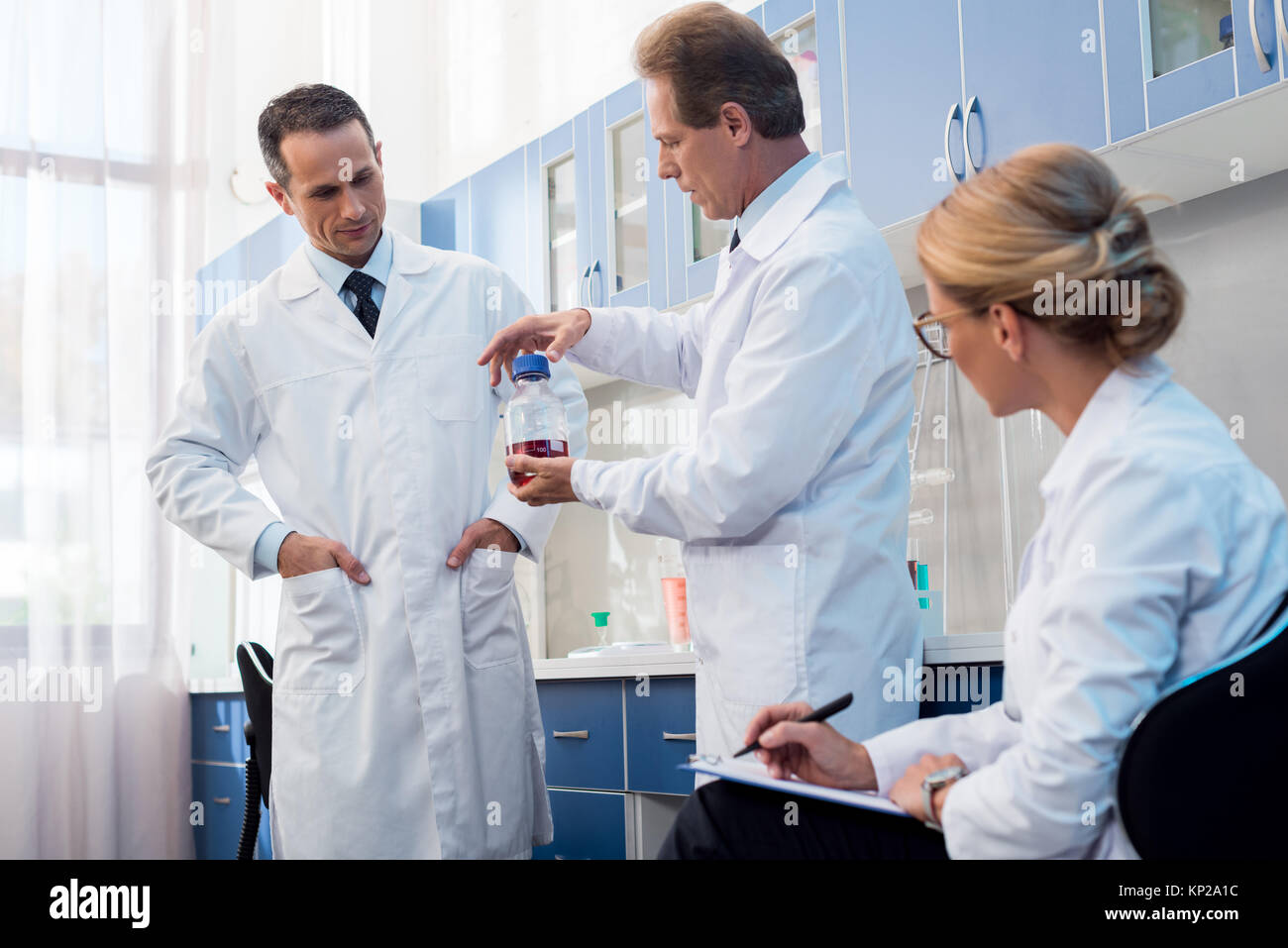 Scientists making experiment Stock Photo - Alamy