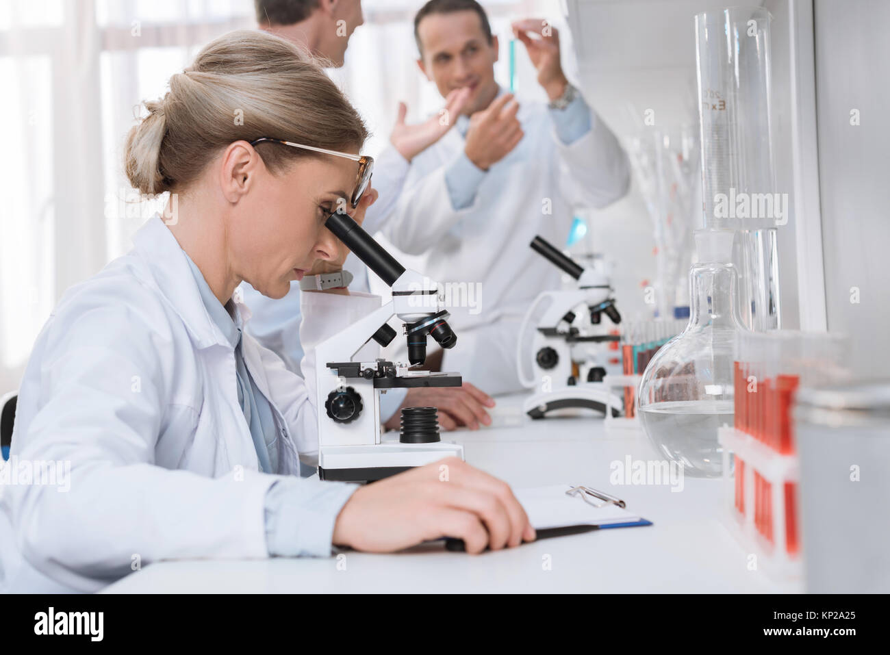 Scientist with microscope in lab Stock Photo - Alamy