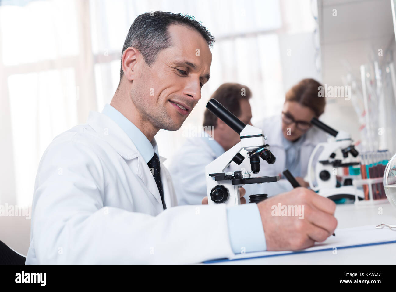 lab technician taking notes Stock Photo - Alamy