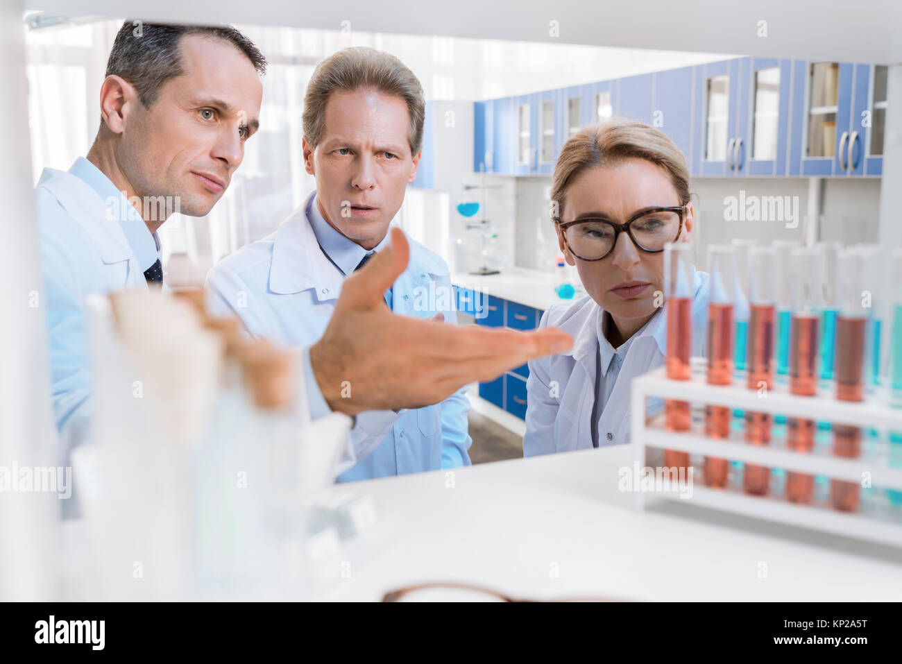 Scientists with test tubes Stock Photo - Alamy