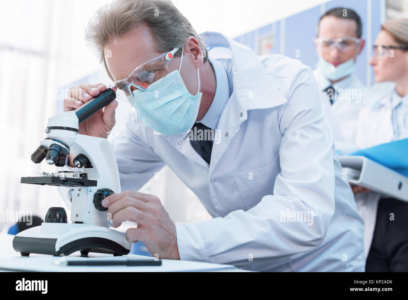 Scientist working with microscope Stock Photo - Alamy