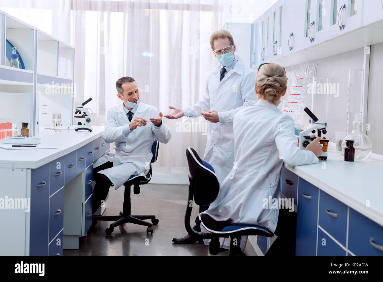 Medical workers talking in laboratory Stock Photo - Alamy