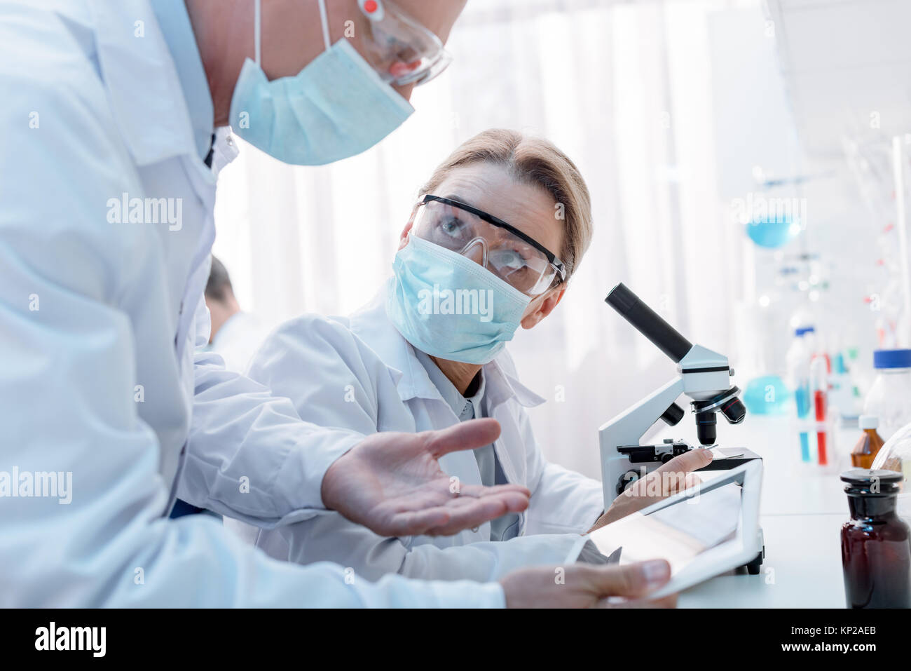 Doctors working with microscope Stock Photo - Alamy