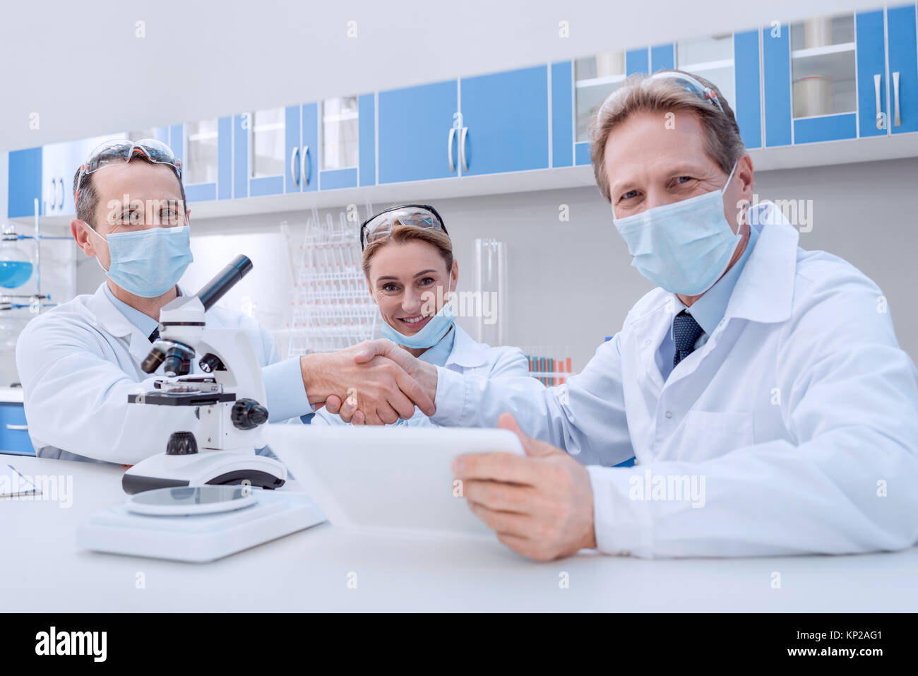 Scientists shaking hands Stock Photo - Alamy