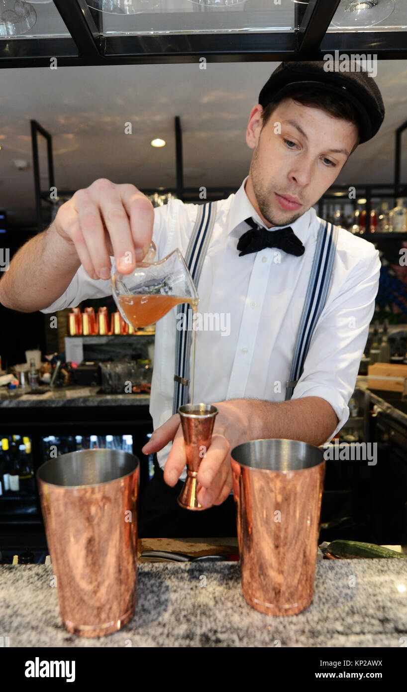 A barman mixing cocktails with Manuka honey Stock Photo - Alamy