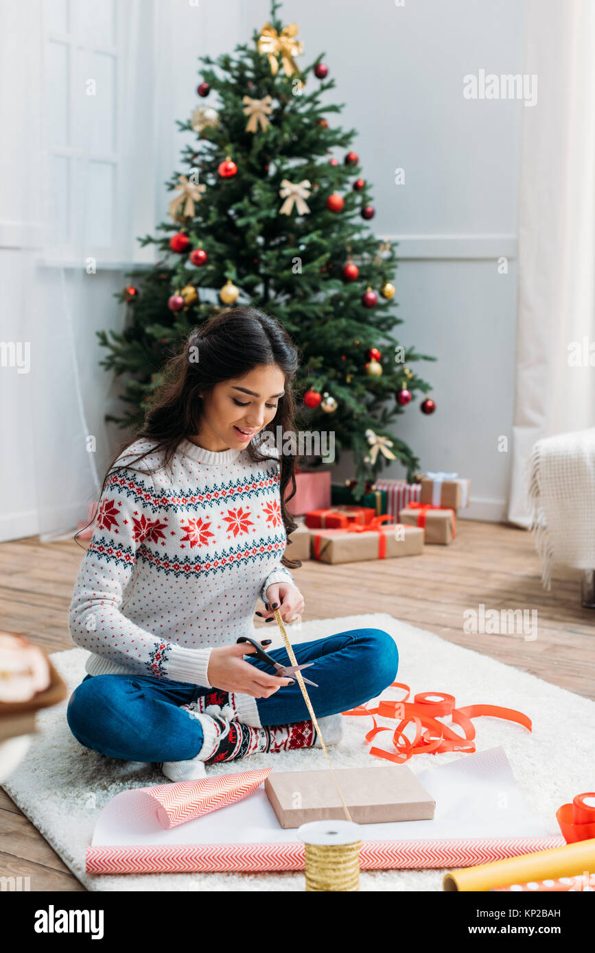 woman packing christmas gift Stock Photo - Alamy