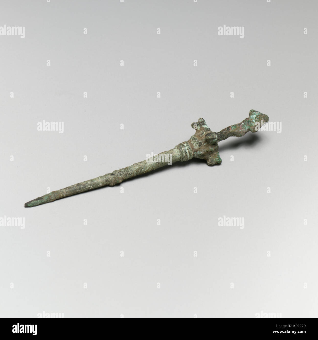 This photograph shows a Greek or Roman bronze pin, an ancient metal ...