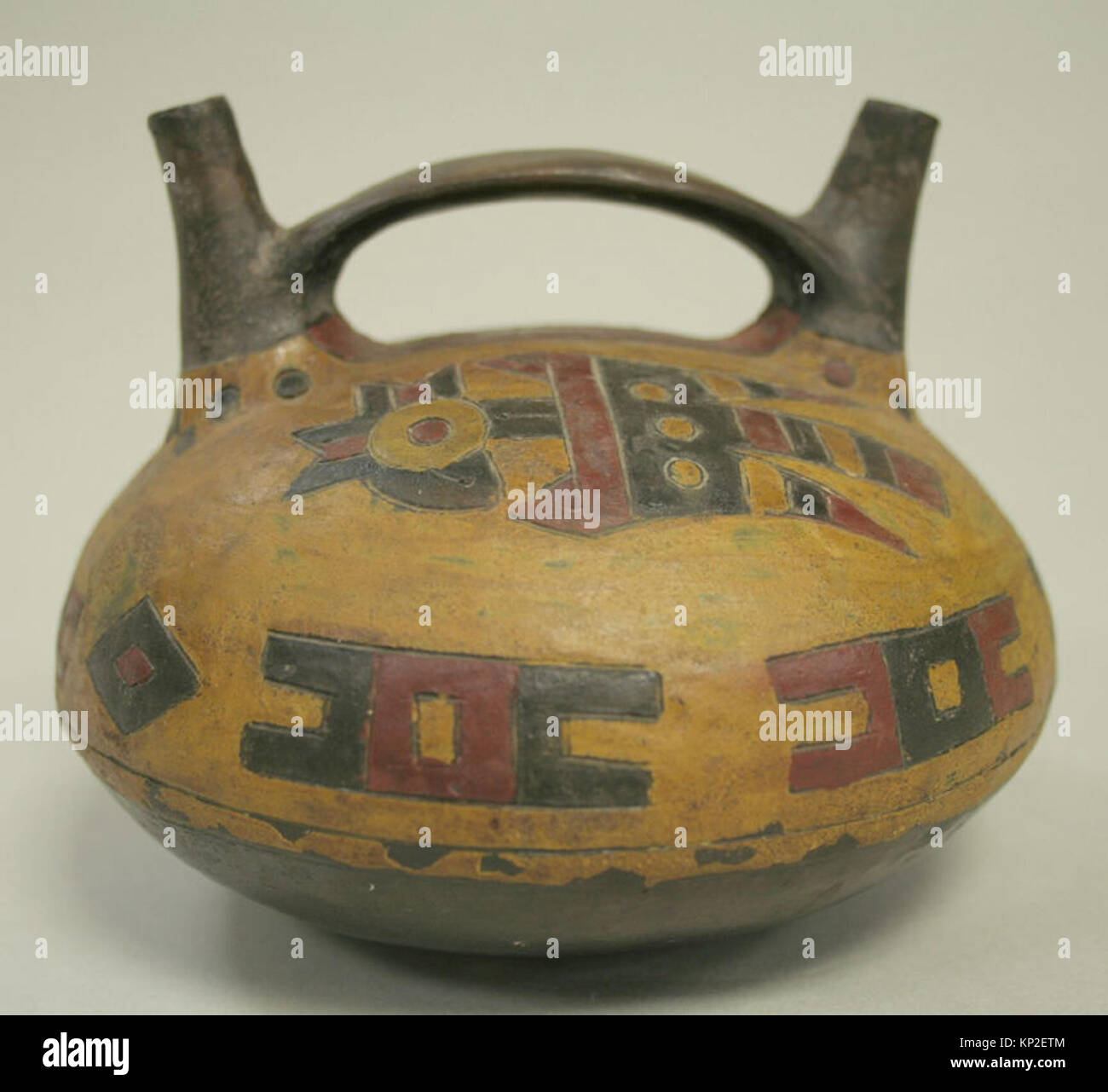 A double spout and bridge bottle featuring bird motifs, made from ...