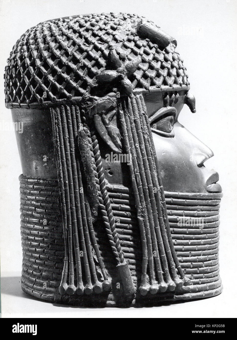 A sculpted head of an Oba, showing detailed facial features, ceremonial ...
