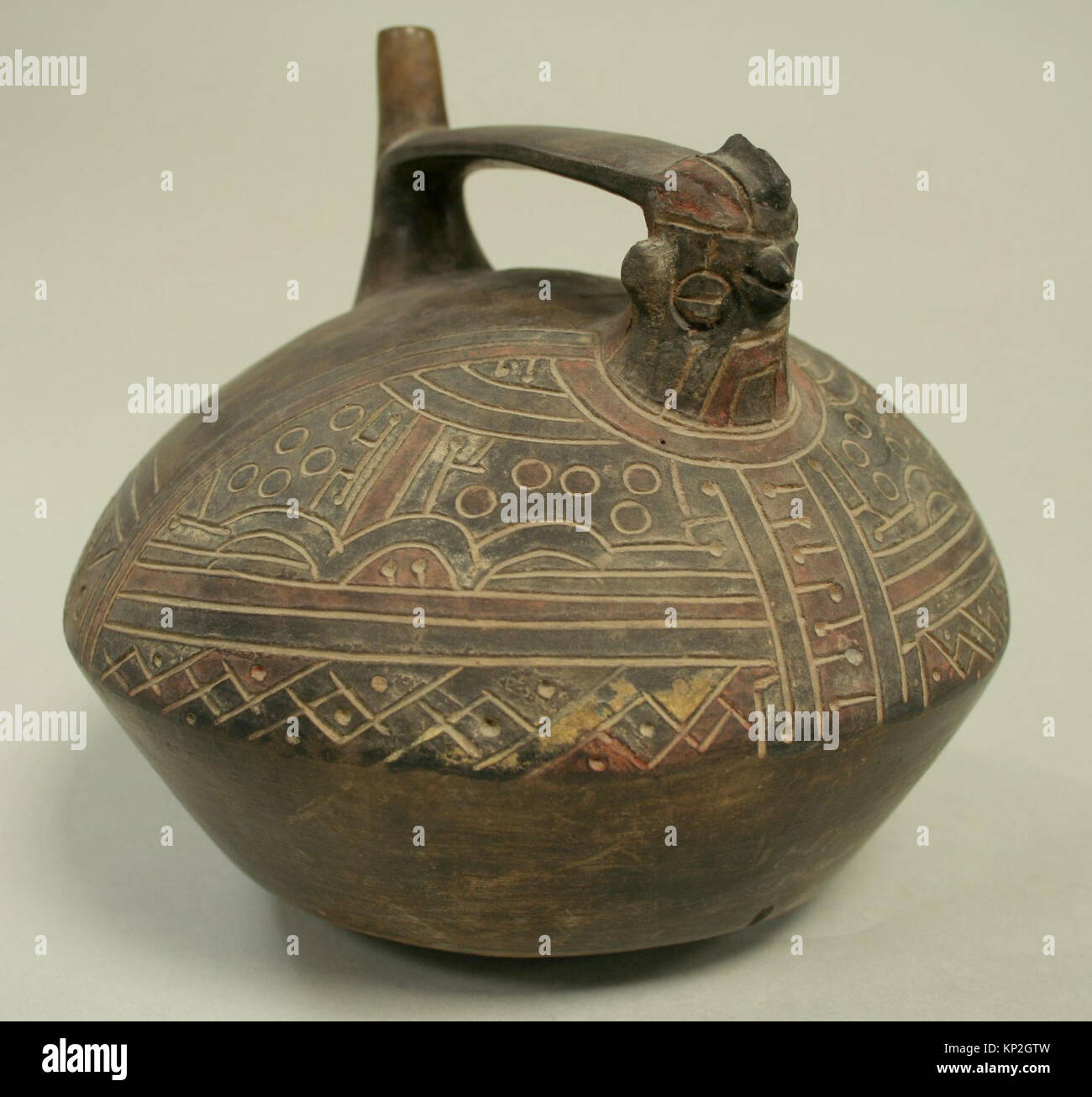 This ceramic double spout and bridge bottle shows a bird decoration ...