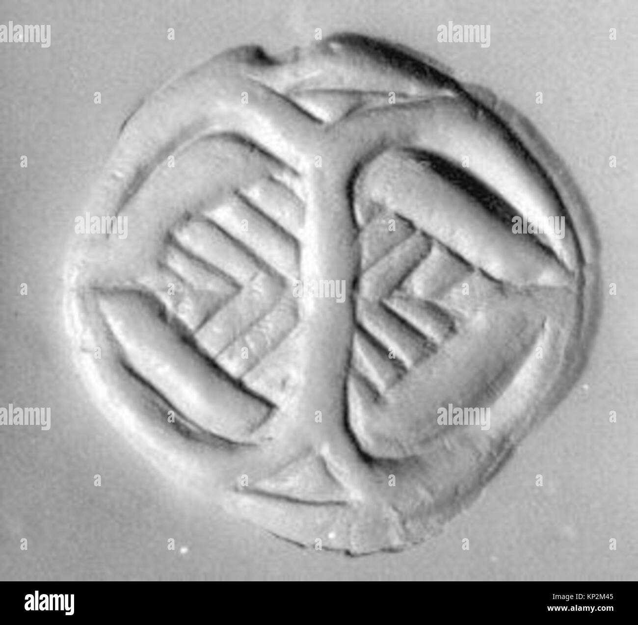 This carinated lentoid seal is a small engraved object used for ...