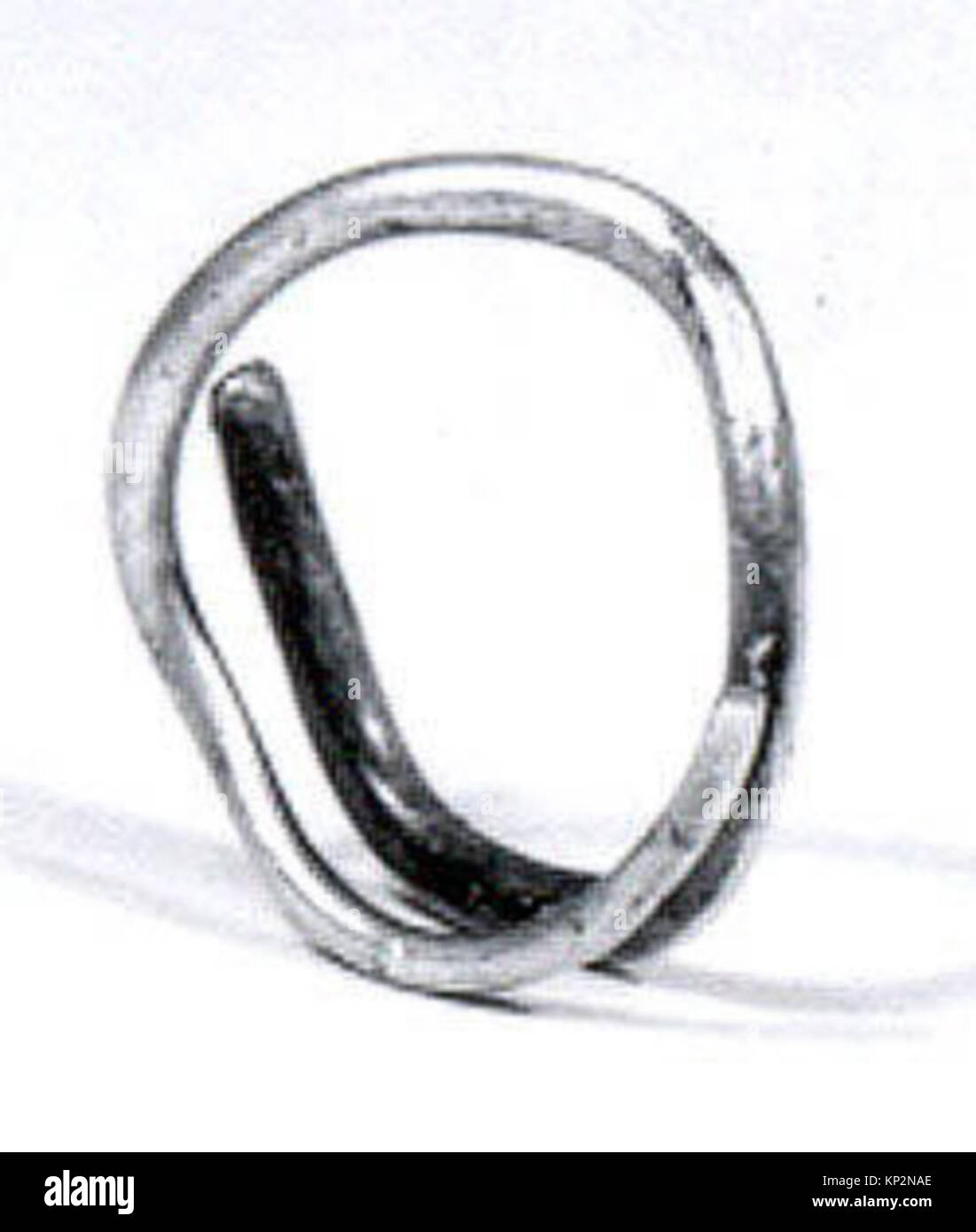 A coiled object, likely made of metal or ceramic, used for functional ...