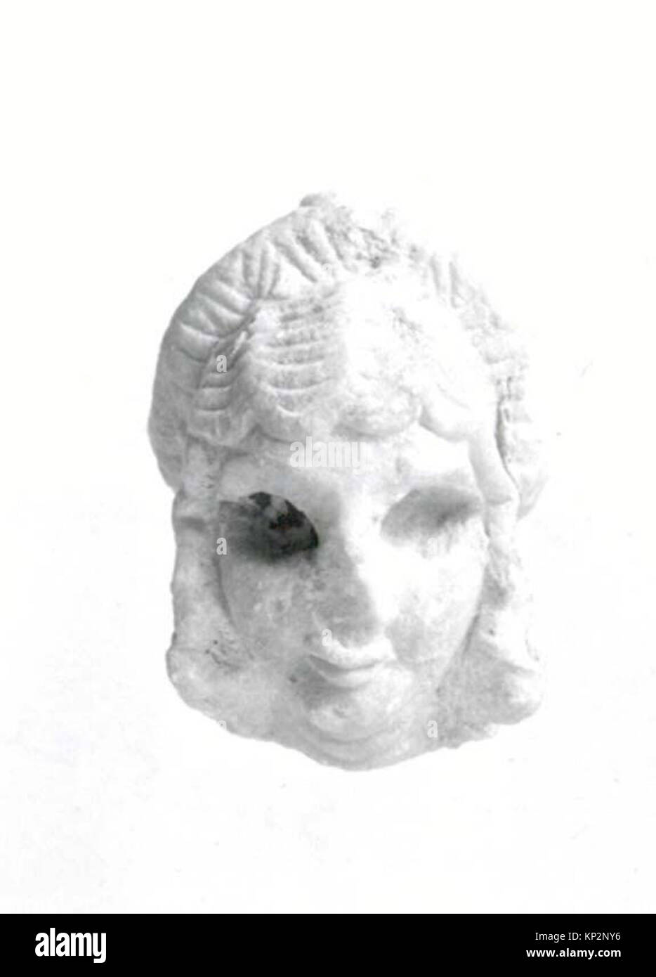 A sculpted female head featuring an elaborate hairstyle, reflecting ...