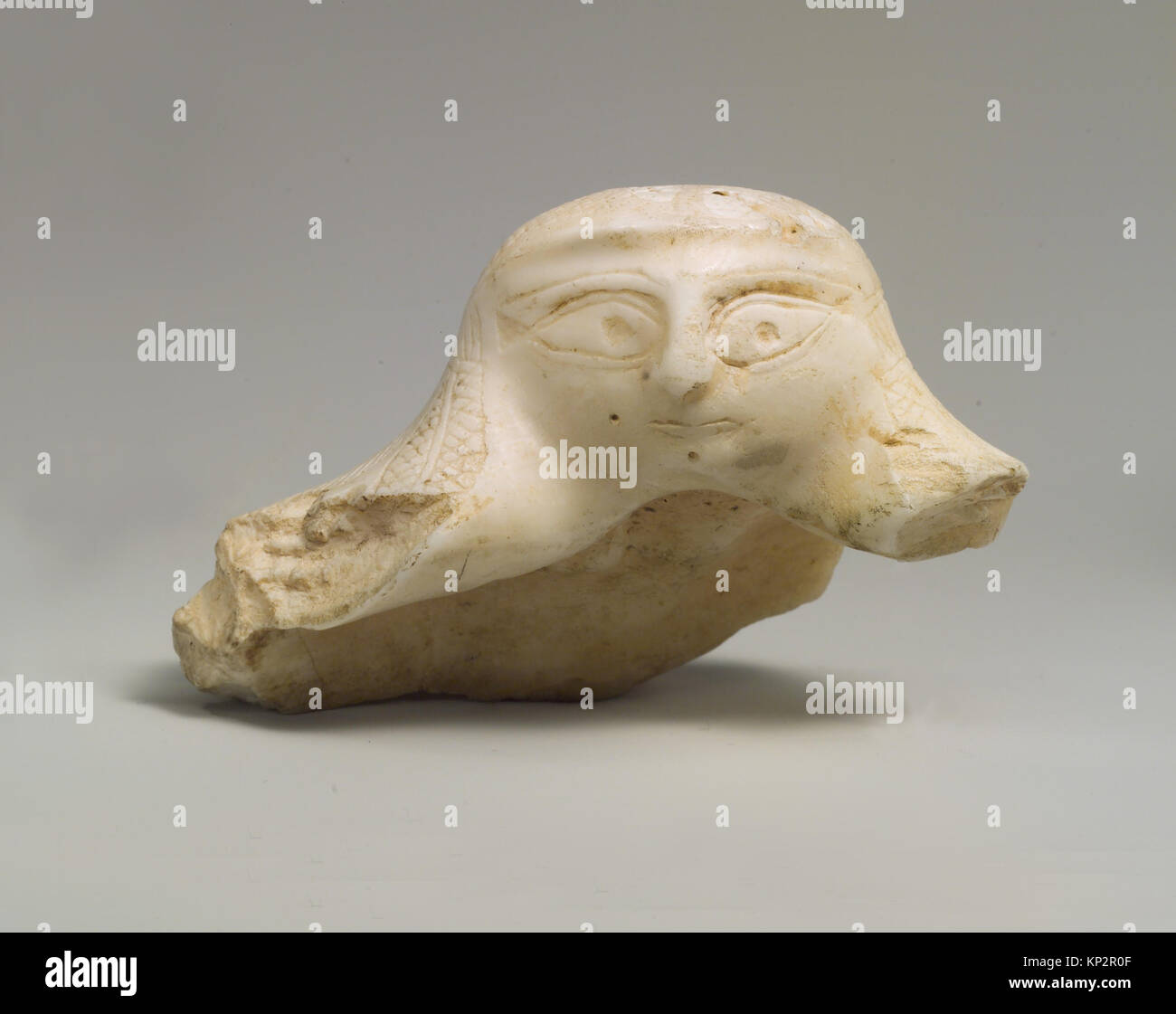 This fragment is part of a cosmetic container made from a large clam ...