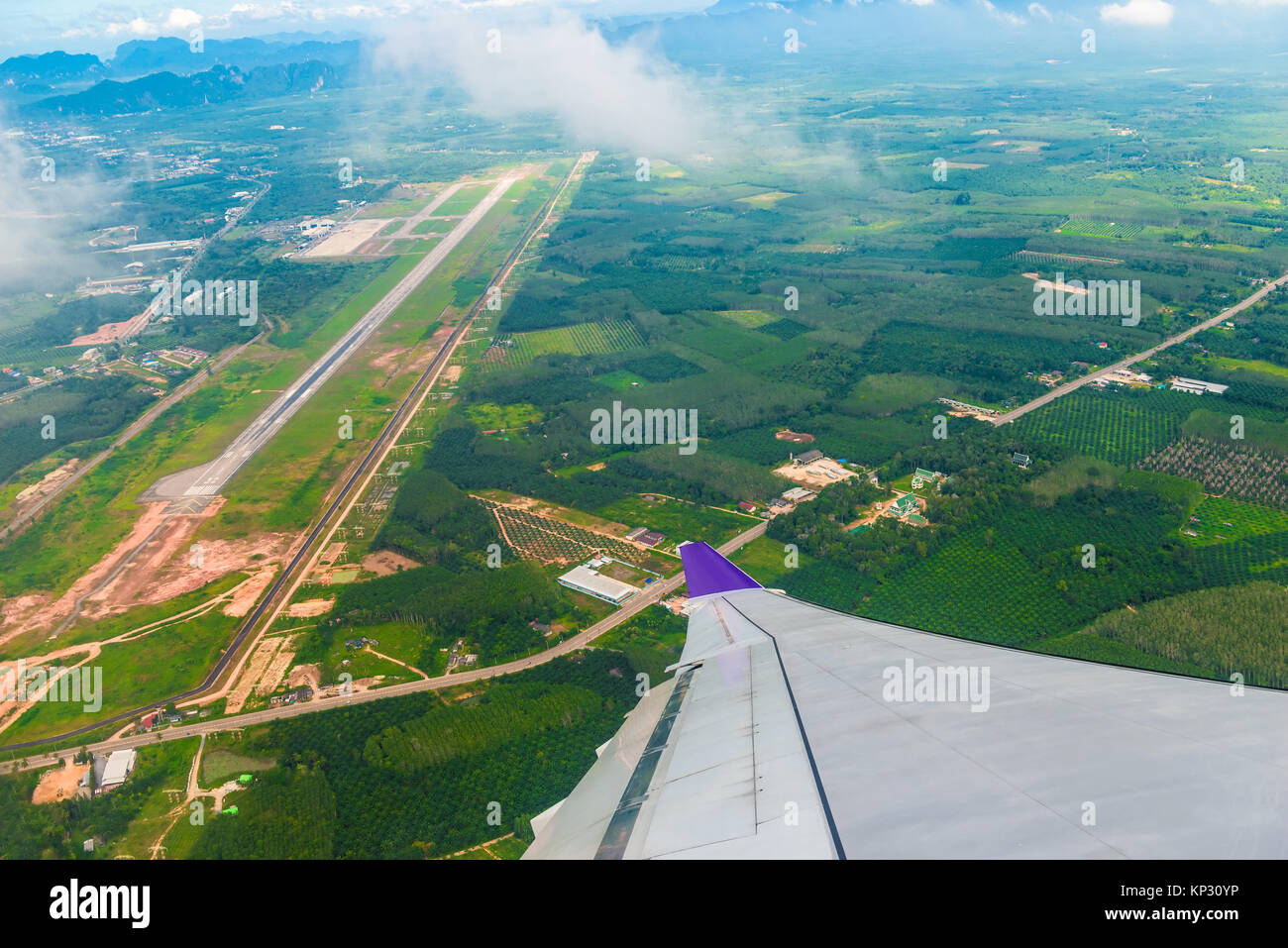 aircraft wing close-up and green fields and forest landscape from the ...