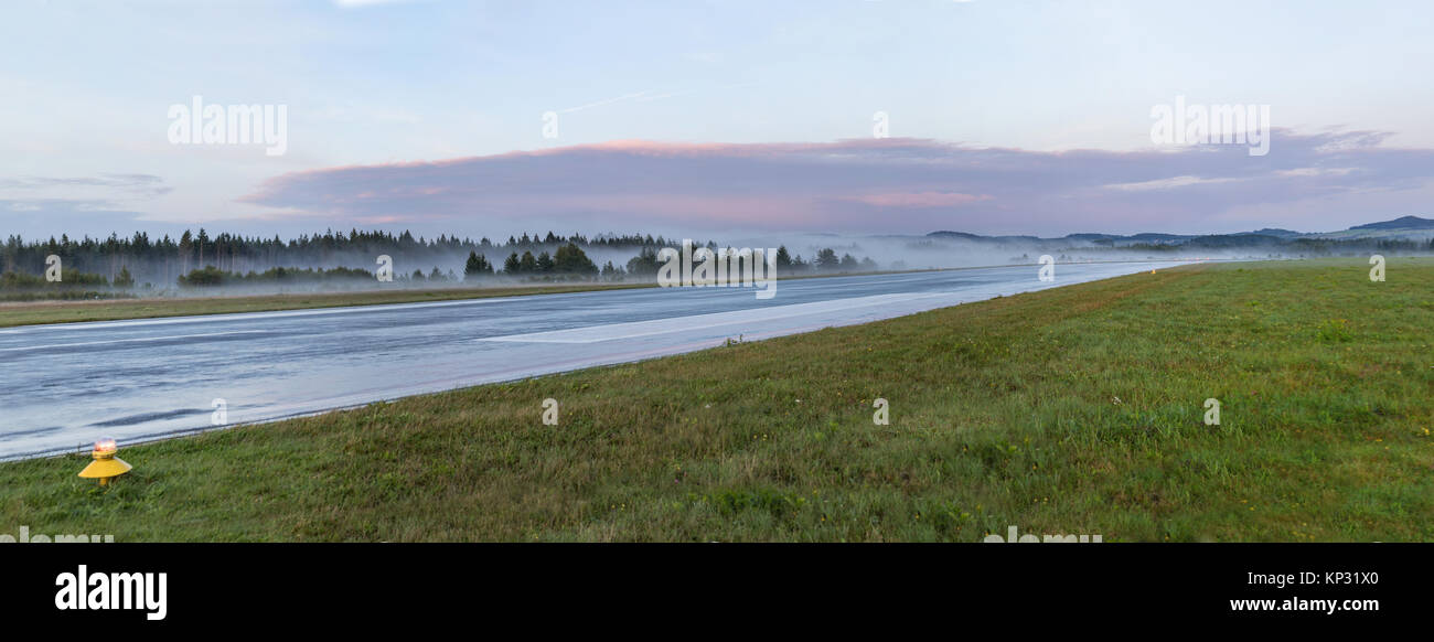 Empty runway at airport during a foggy sunrise. Foggy runway Stock ...