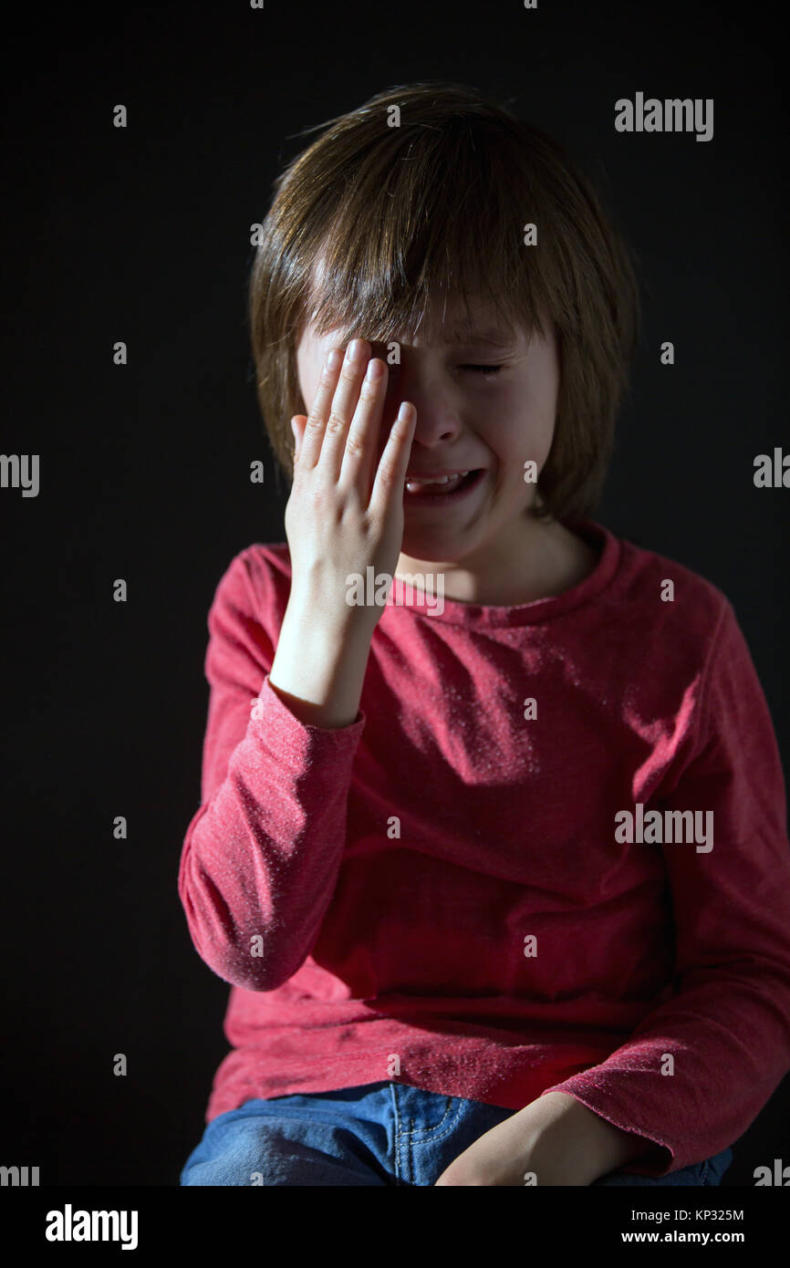 Sad little child, crying, hugging stuffed toy, tears in his eyes Stock ...