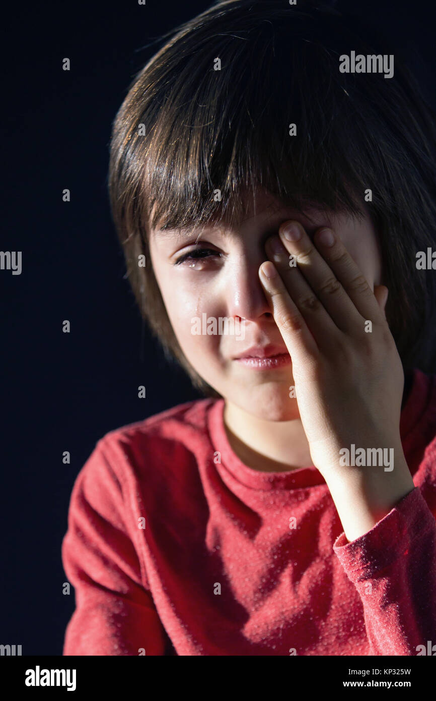 Sad little child, crying, hugging stuffed toy, tears in his eyes Stock ...