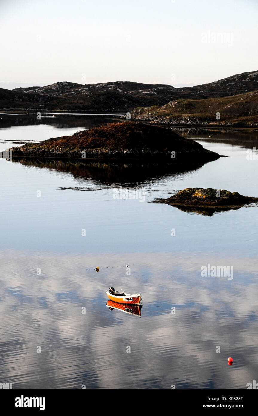 A moored rowing boat in Badcall Bay in Sutherland, northwest Scotland ...