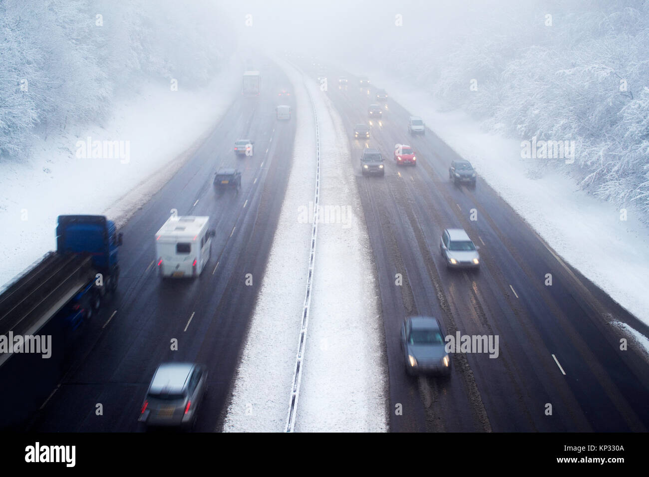 Traffic On Motorway During Snow Storm Stock Photo - Alamy