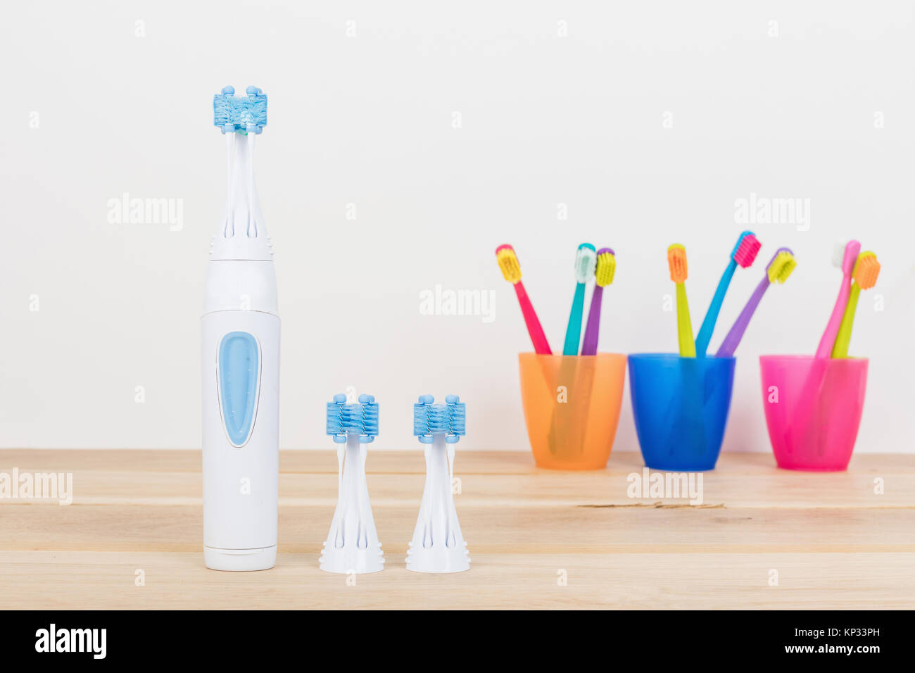 Ultra fine toothbrushes in colorful glasses and electric modern tooth ...
