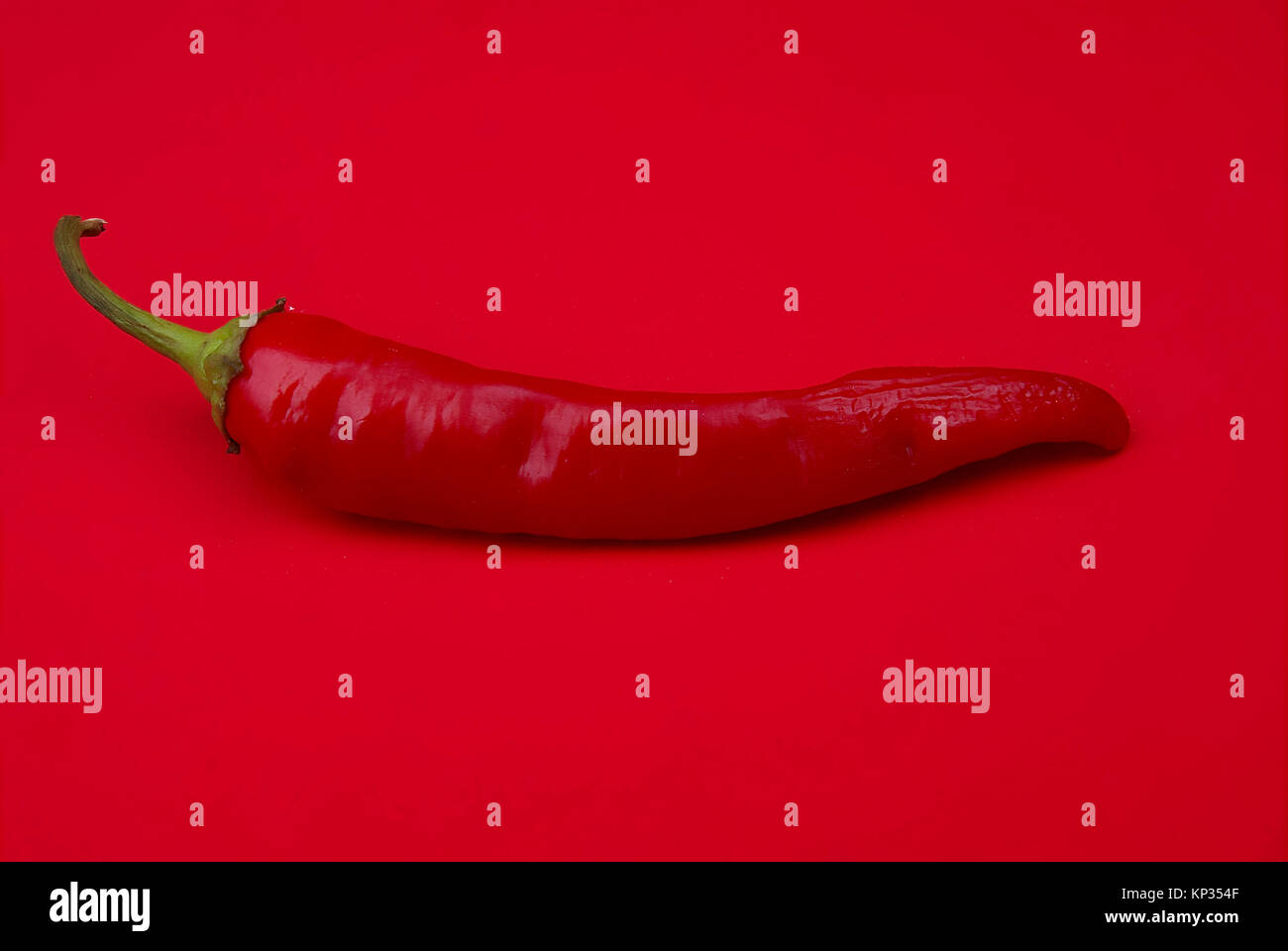 Red pepper isolated on red background Stock Photo - Alamy