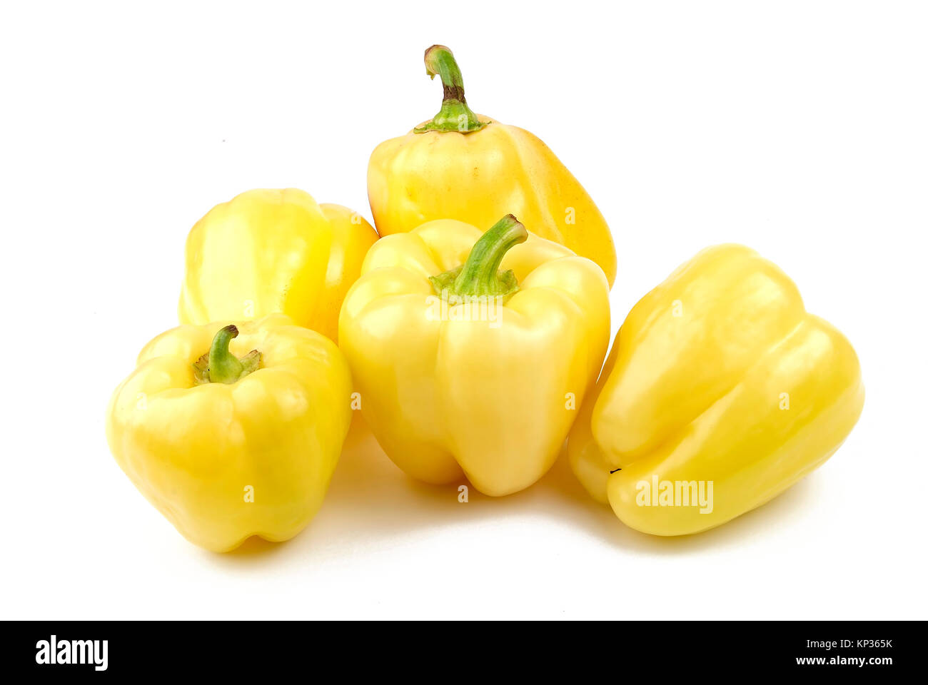 Group of yellow peppers on white background Stock Photo - Alamy