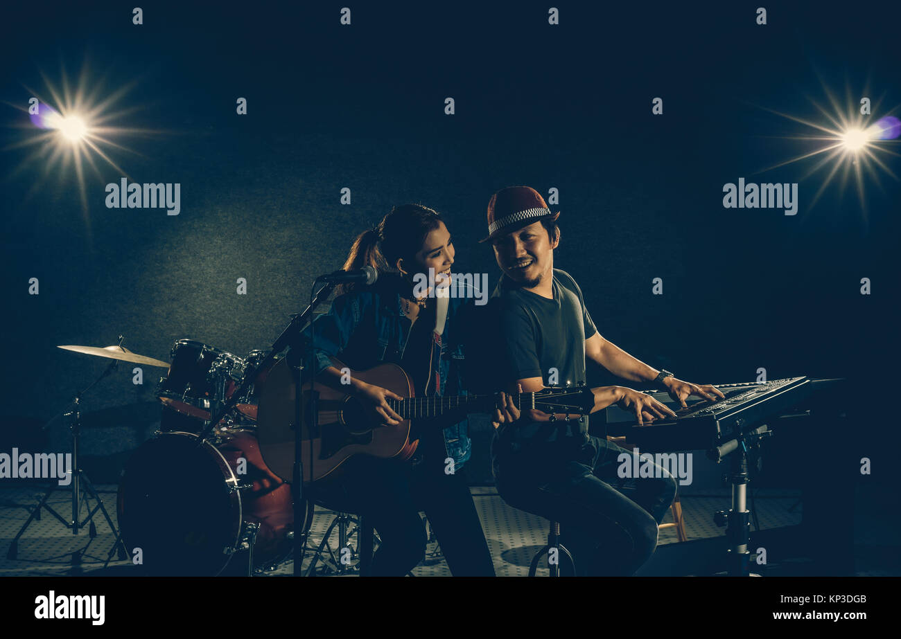 Musician duo band singing a song and playing music instrument with ...