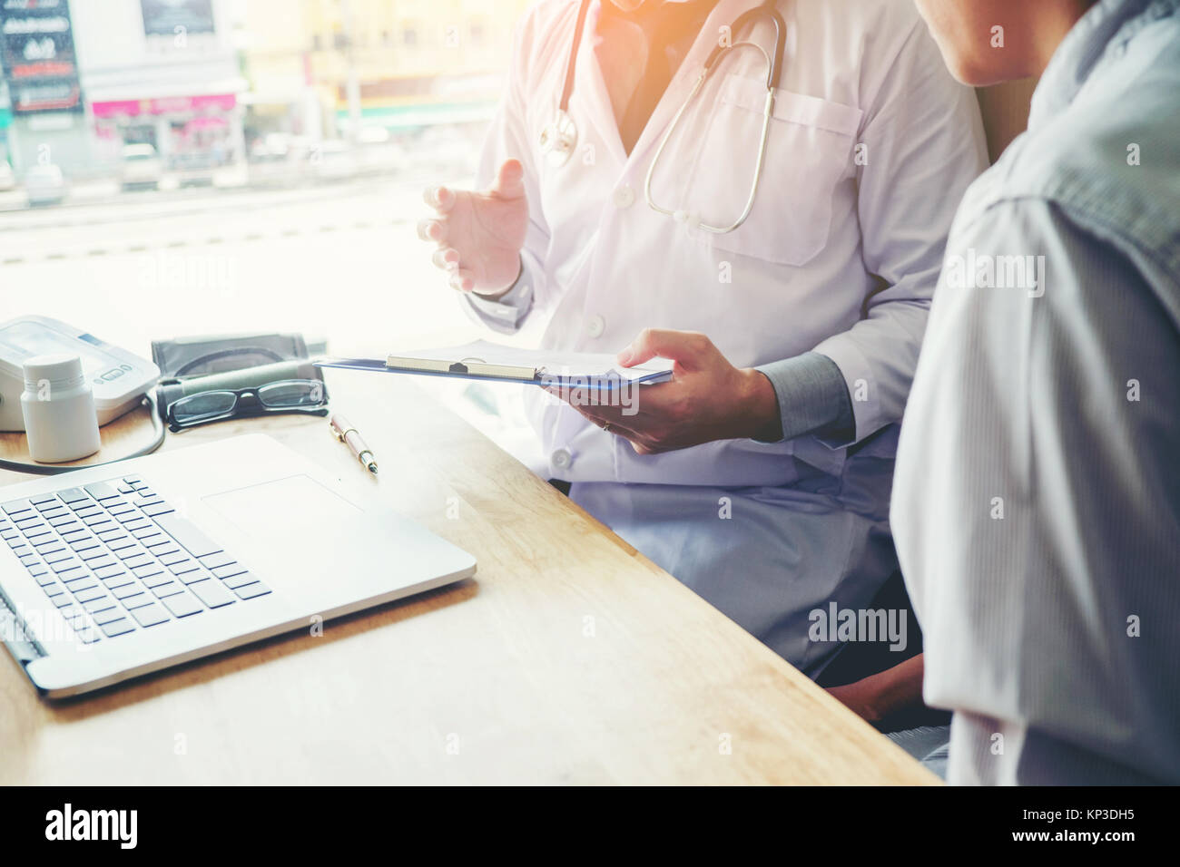 Doctors and patients sit and talk. At the table near the window in the ...