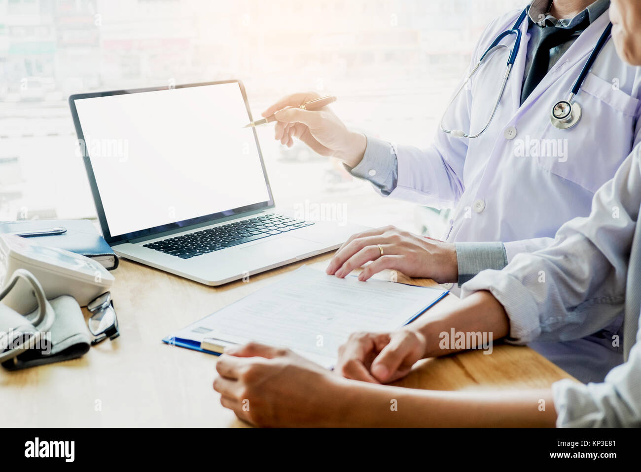 Doctor consulting with patient presenting results on blank Screen ...