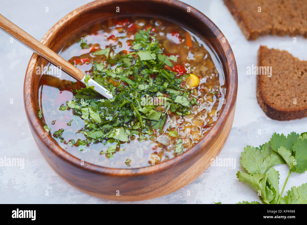 Peruvian soup with quinoa, red rice and lentils in a wooden bowl with ...