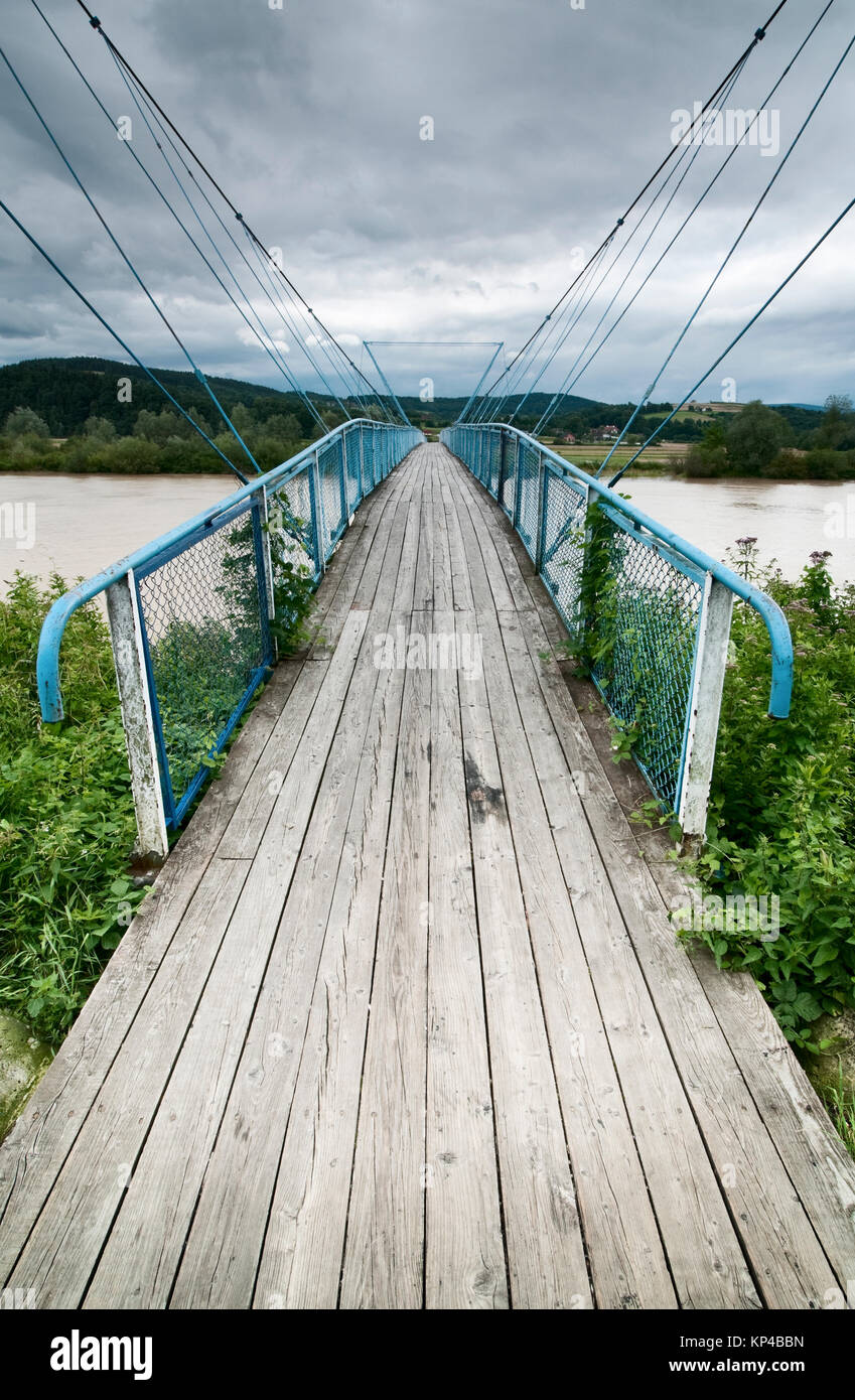Bridge over brown river in countryside Stock Photo - Alamy