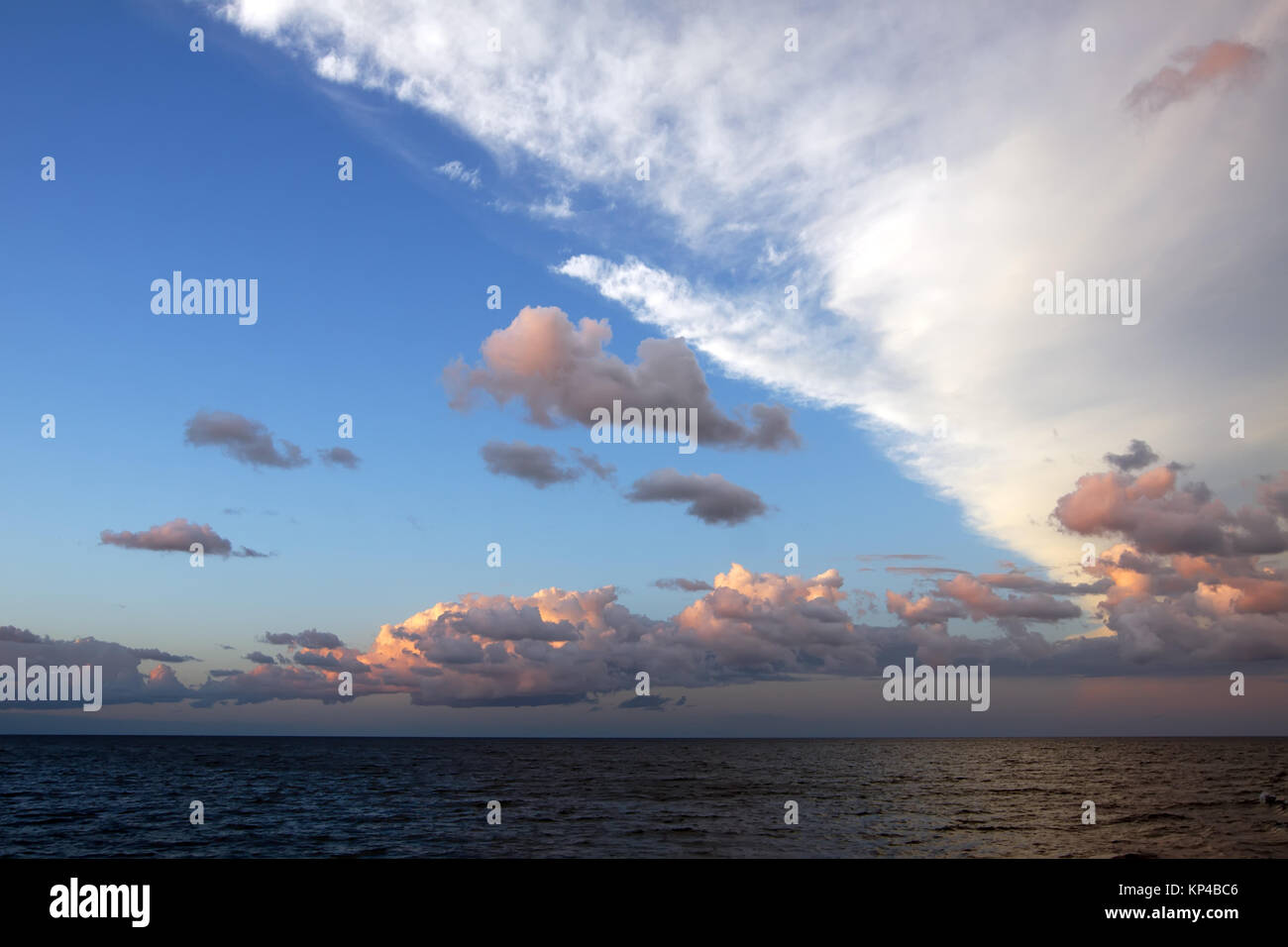 Cloud formation over a large body of water at sunset Stock Photo - Alamy