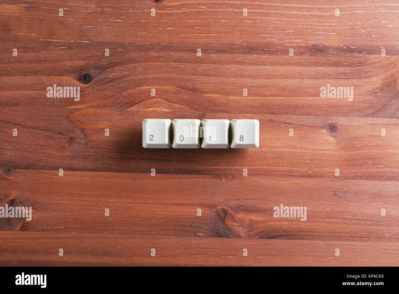 2018 word. Flat lay view from above on the table with computer keyboard keys buttons on a wooden ...