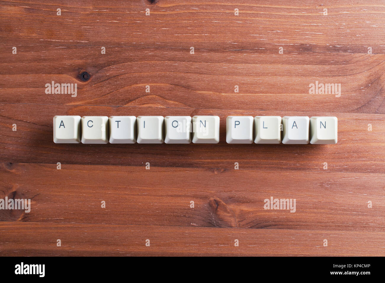 Action plan words on keyboard. Flat lay view from above on the table with computer keyboard keys ...