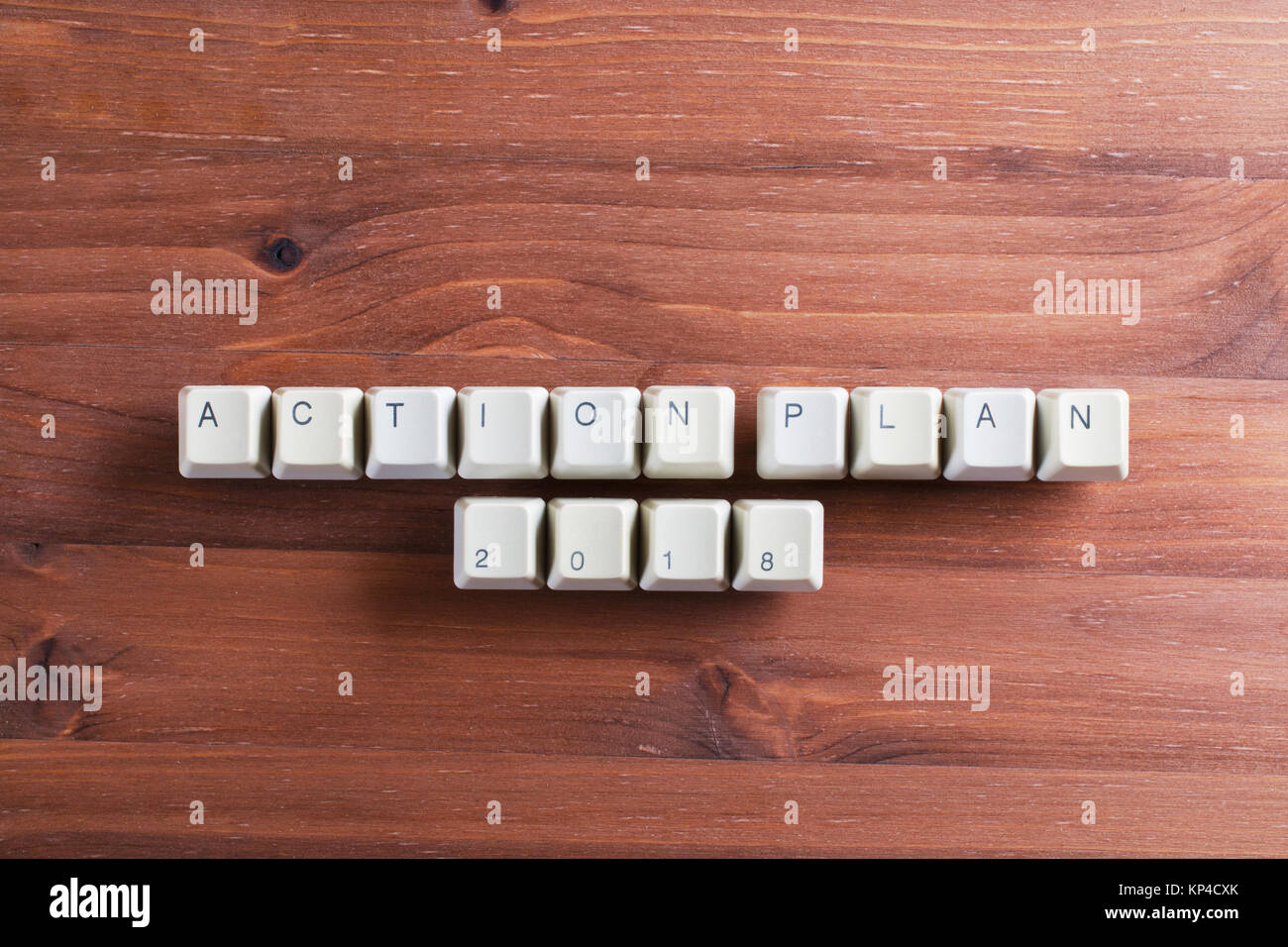 Action plan 2018. Flat lay view from above on the table with computer keyboard keys buttons on a ...