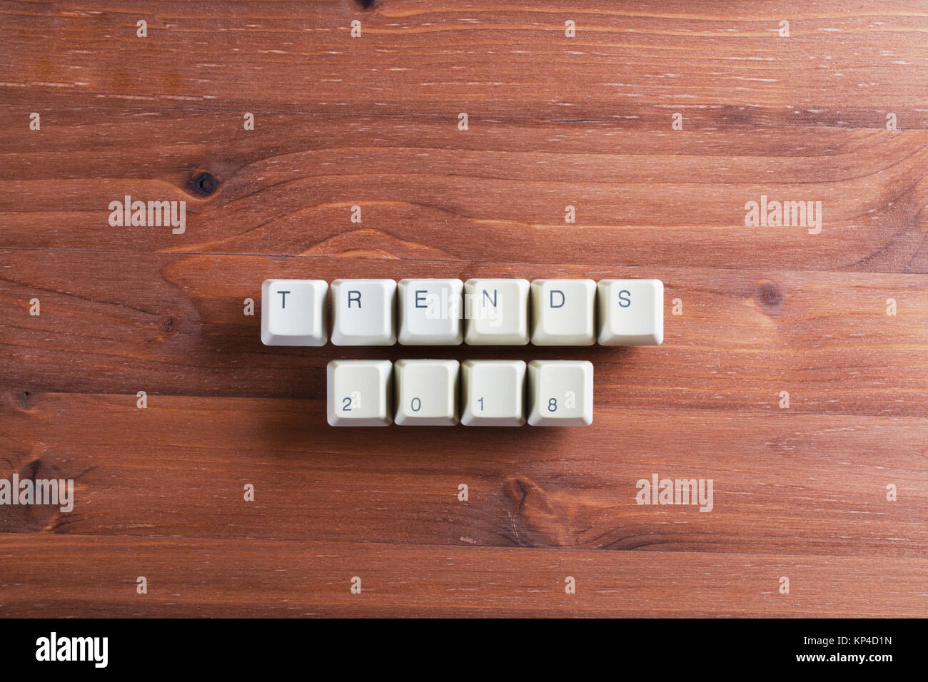 Trends 2018. Flat lay view from above on the table with computer keyboard keys buttons on a ...