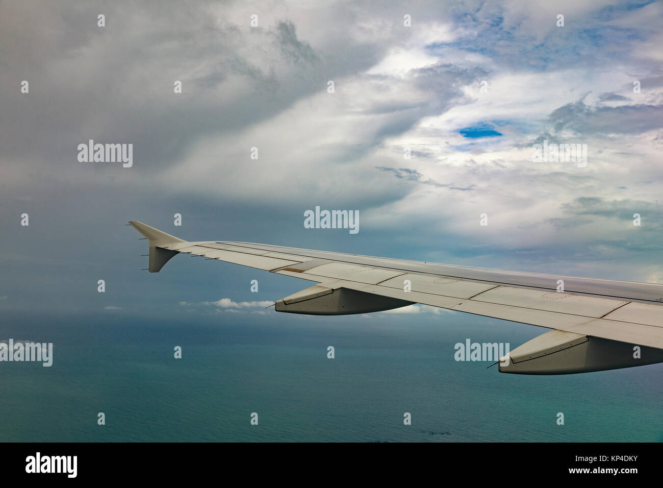 Wing of aeroplane over ocean island hi-res stock photography and images ...